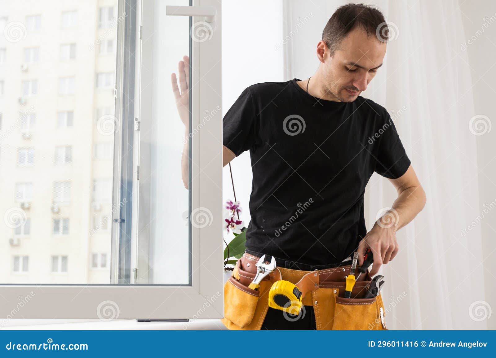 Young Repairman Fixing Window Frame in Room at Daytime Stock Photo ...