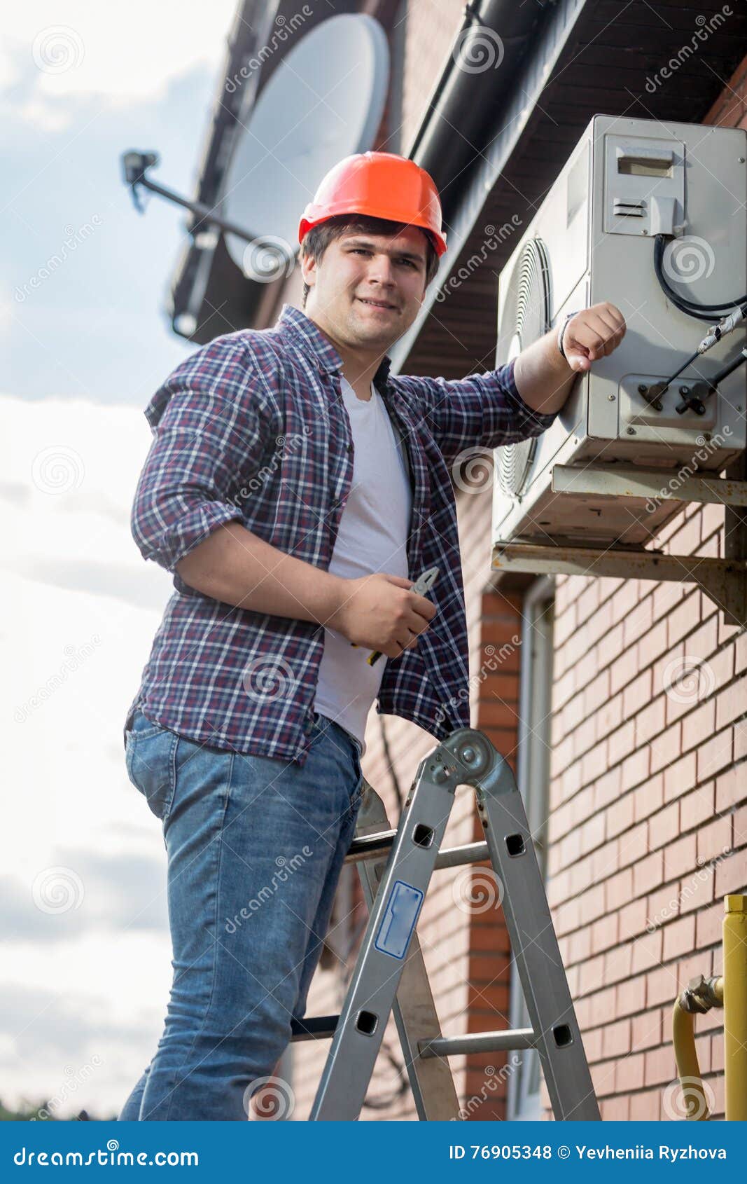 Young Repairman Installing Air Conditioner on Outer Wall Stock Photo ...