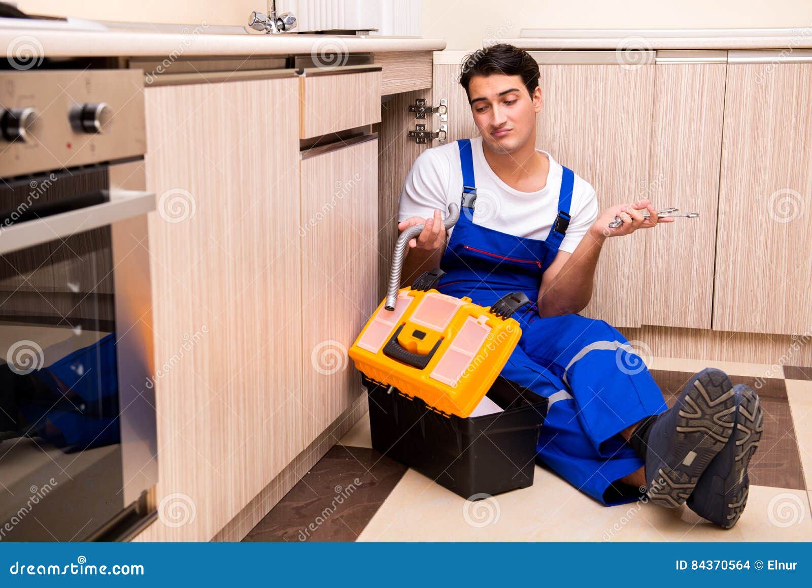 The Young Repairman Working at the Kitchen Stock Photo - Image of ...
