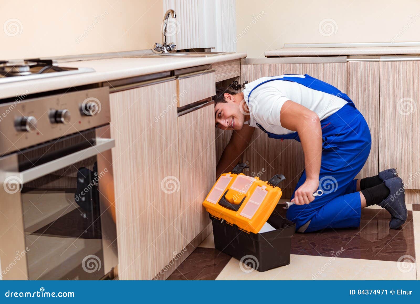 The Young Repairman Working at the Kitchen Stock Image - Image of ...