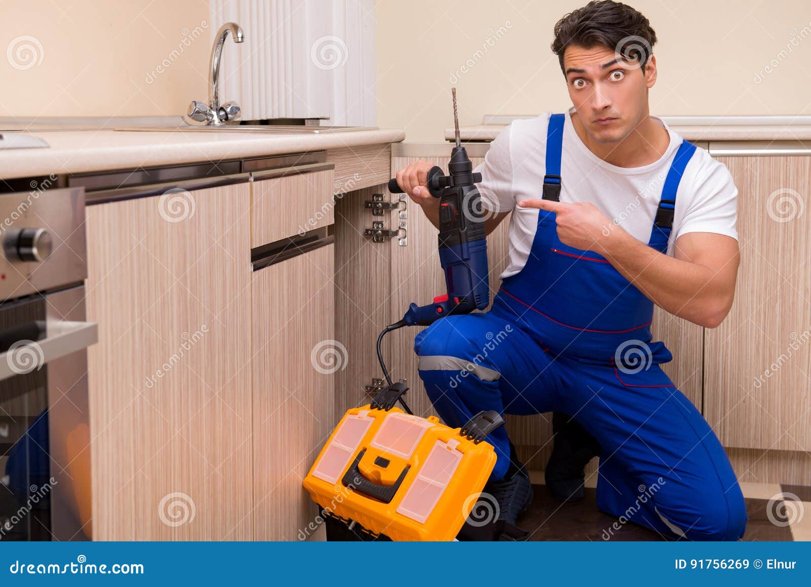 The Young Repairman Working at the Kitchen Stock Image - Image of ...