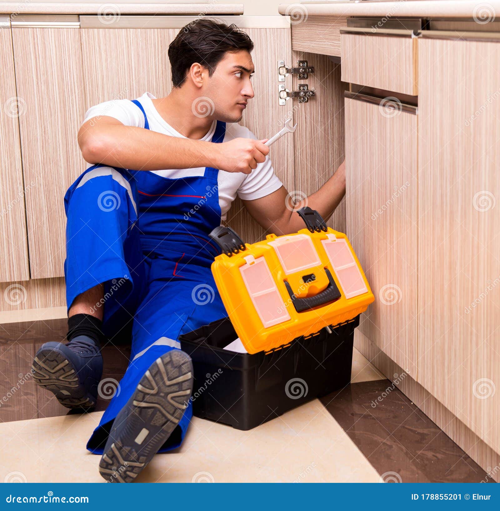 Young Repairman Working at the Kitchen Stock Image - Image of house ...