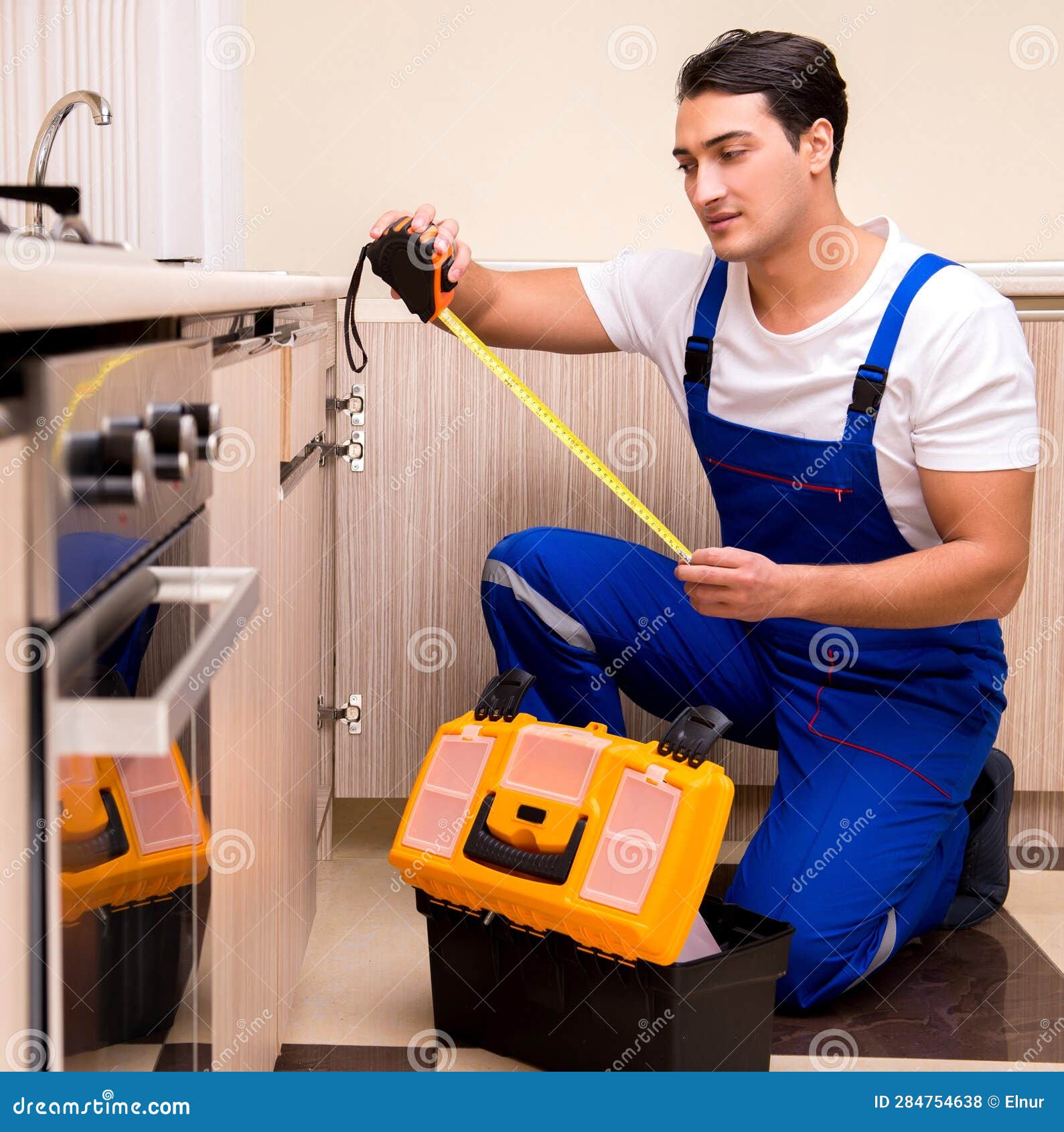 Young Repairman Working at the Kitchen Stock Photo - Image of kitchen ...