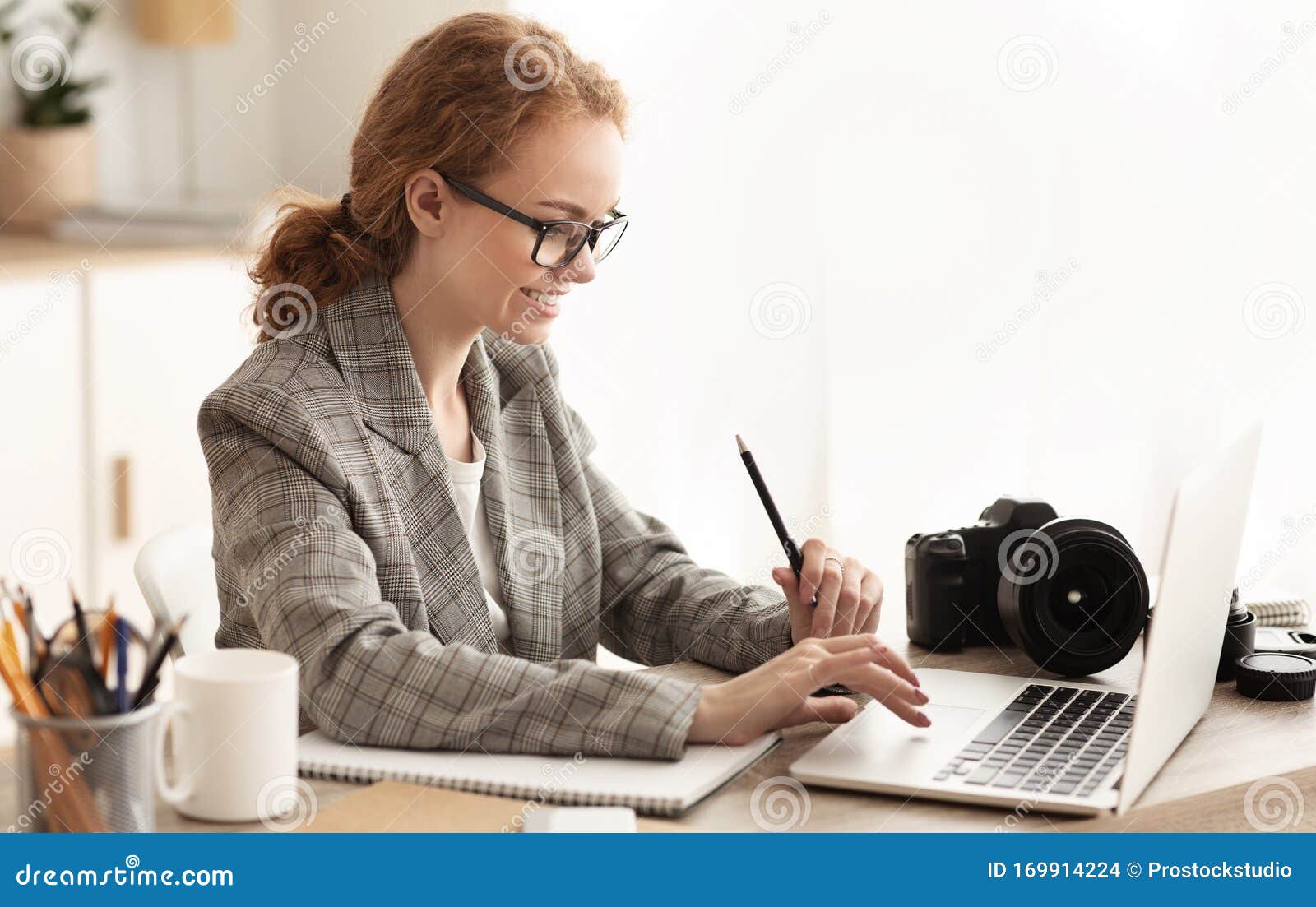 Young Reporter Transfering Image Data from Camera To Laptop Stock Photo ...