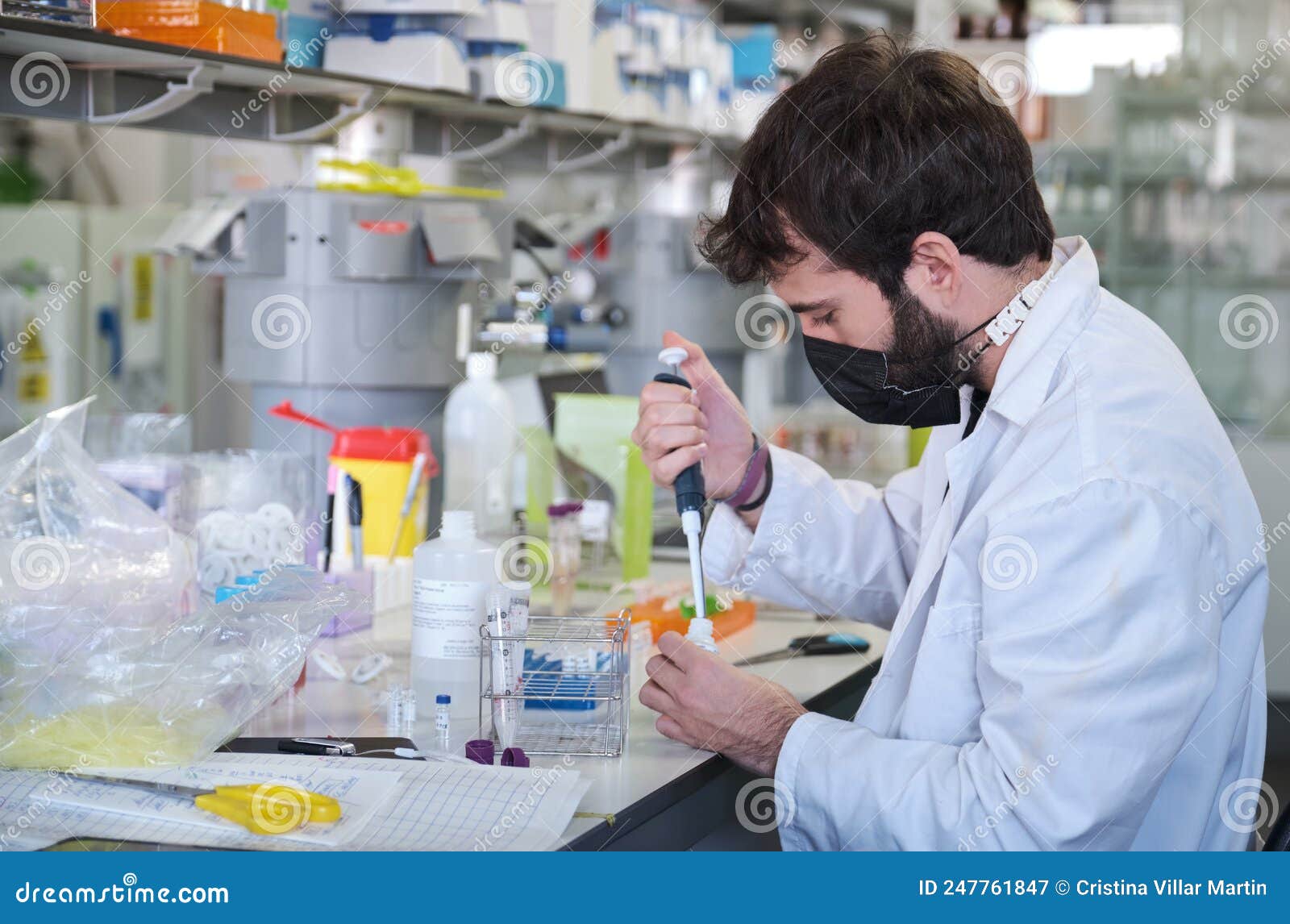 Young Researcher Wearing Protective Face Mask Working in a Real ...