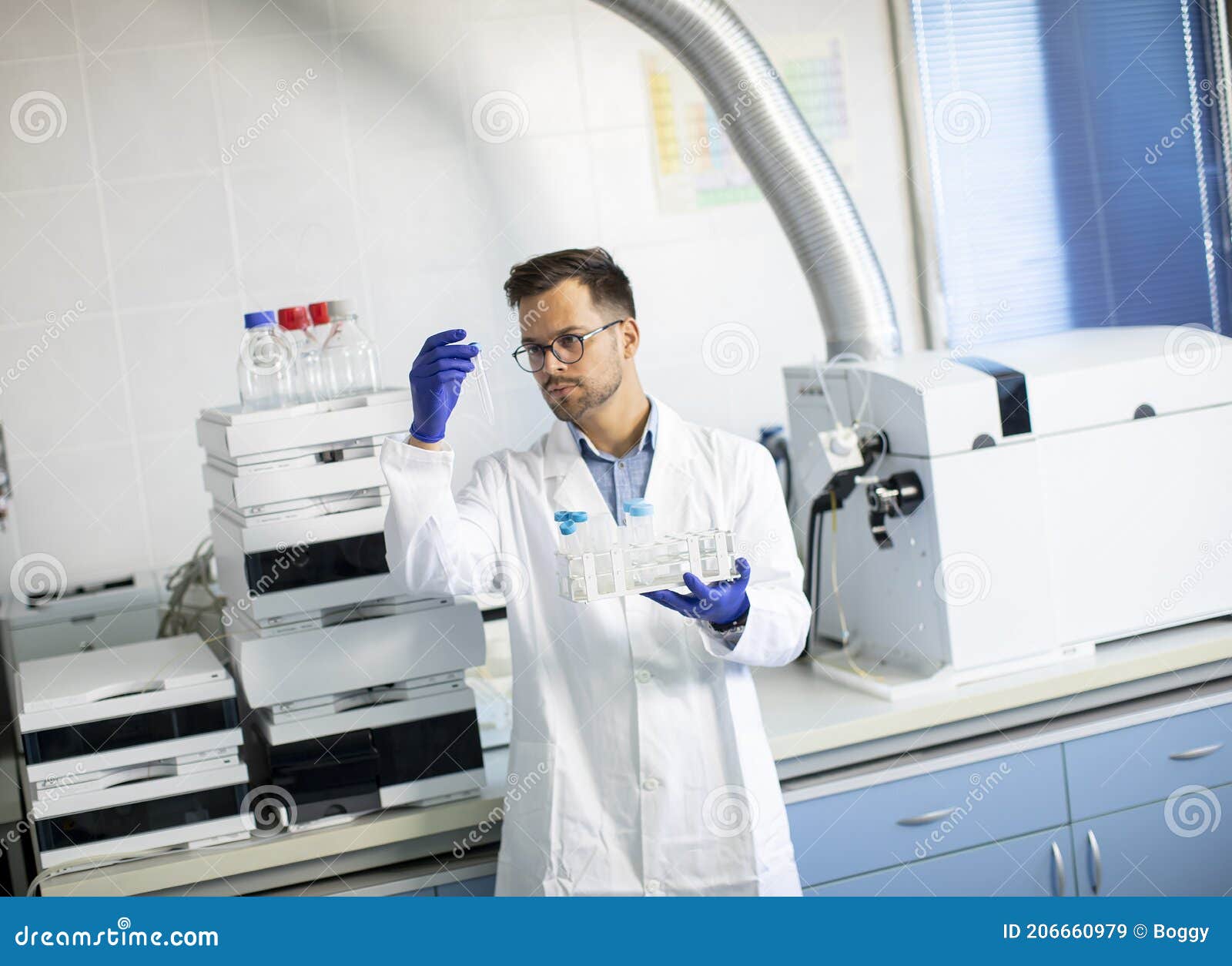 Young Researcher Workin with Chemical Samples in Laboratory with HPLC ...