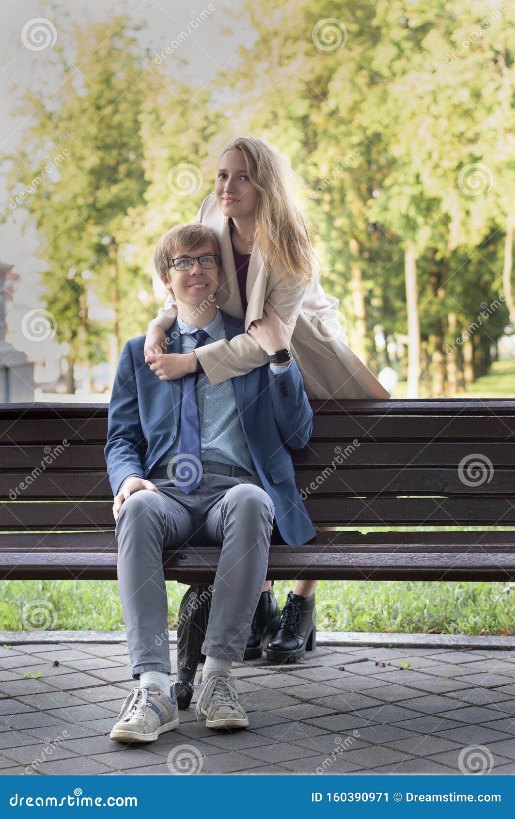 Young Romantic Couple Hugging Sitting on Bench Stock Image - Image of ...
