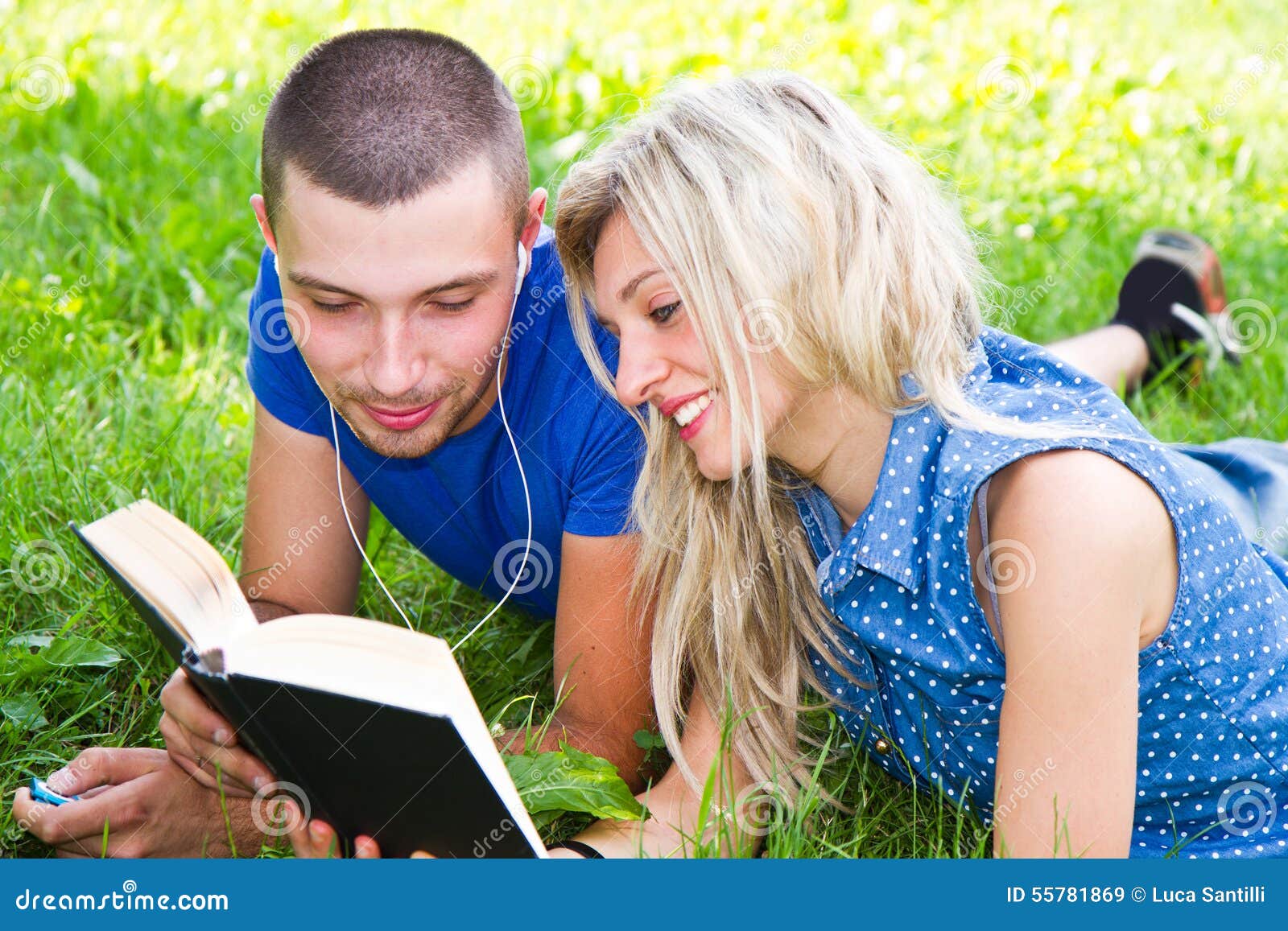 Young Romantic Couple Lying In Park And Reading Stock Image Image Of