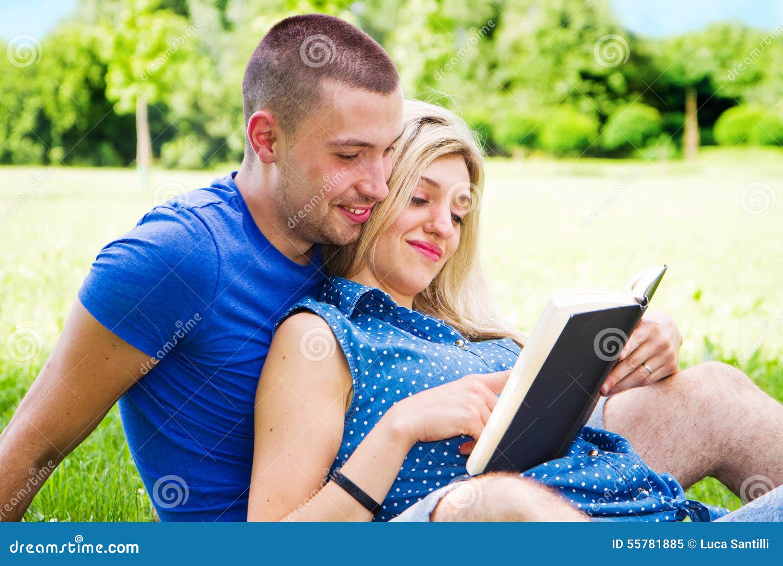 Young Romantic Couple Lying in Park and Reading Stock Image - Image of ...