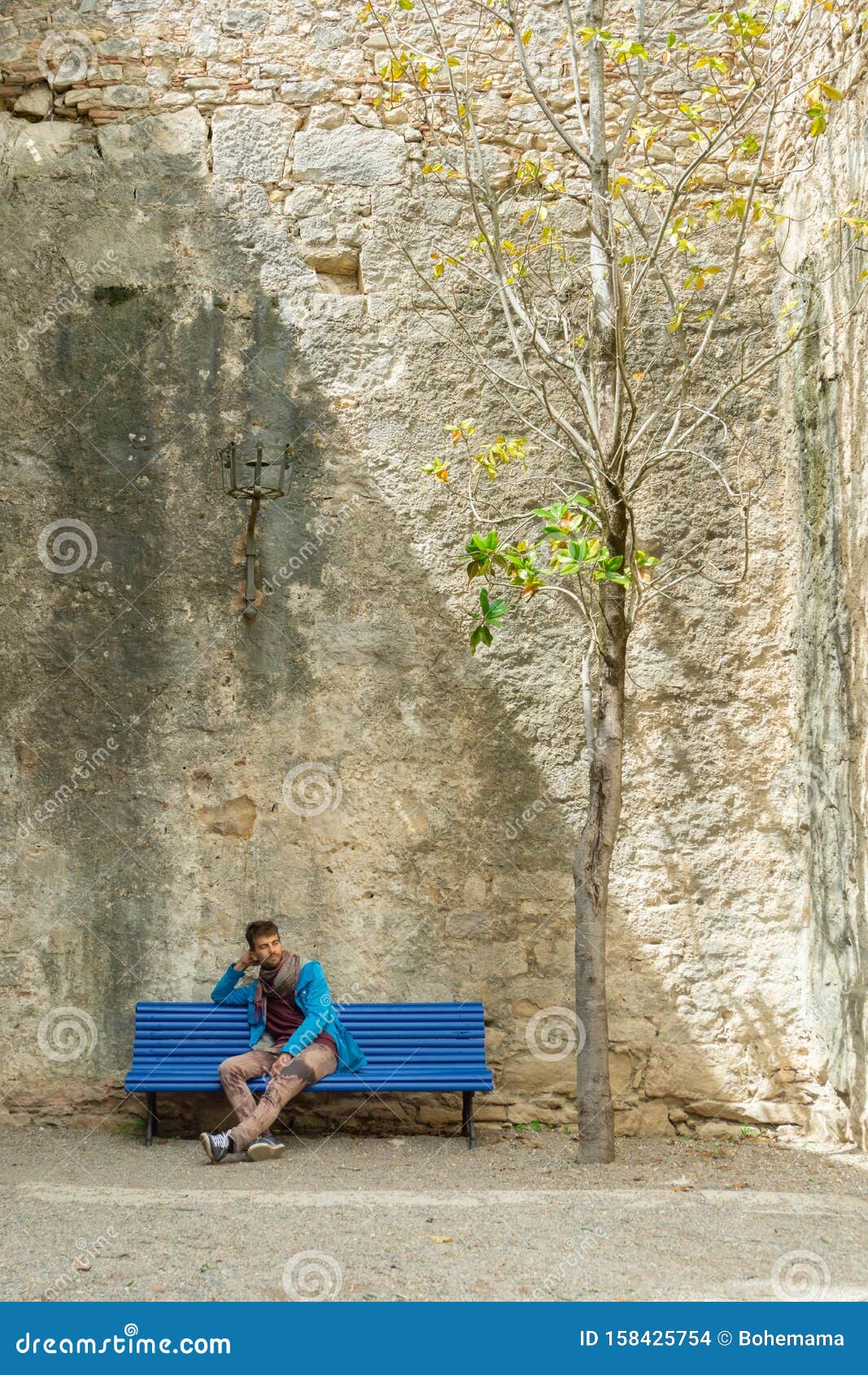 Young Romantic Man Sitting Alone on Bench in Front Stone Wall Stock ...