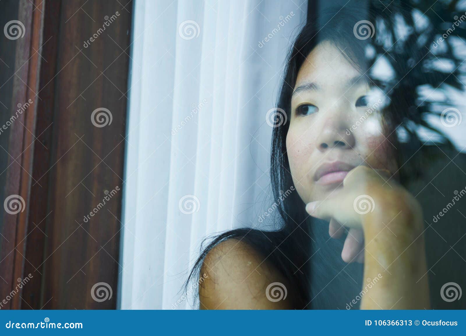 Young Sad And Depressed Asian Chinese Woman Looking Thoughtful Through