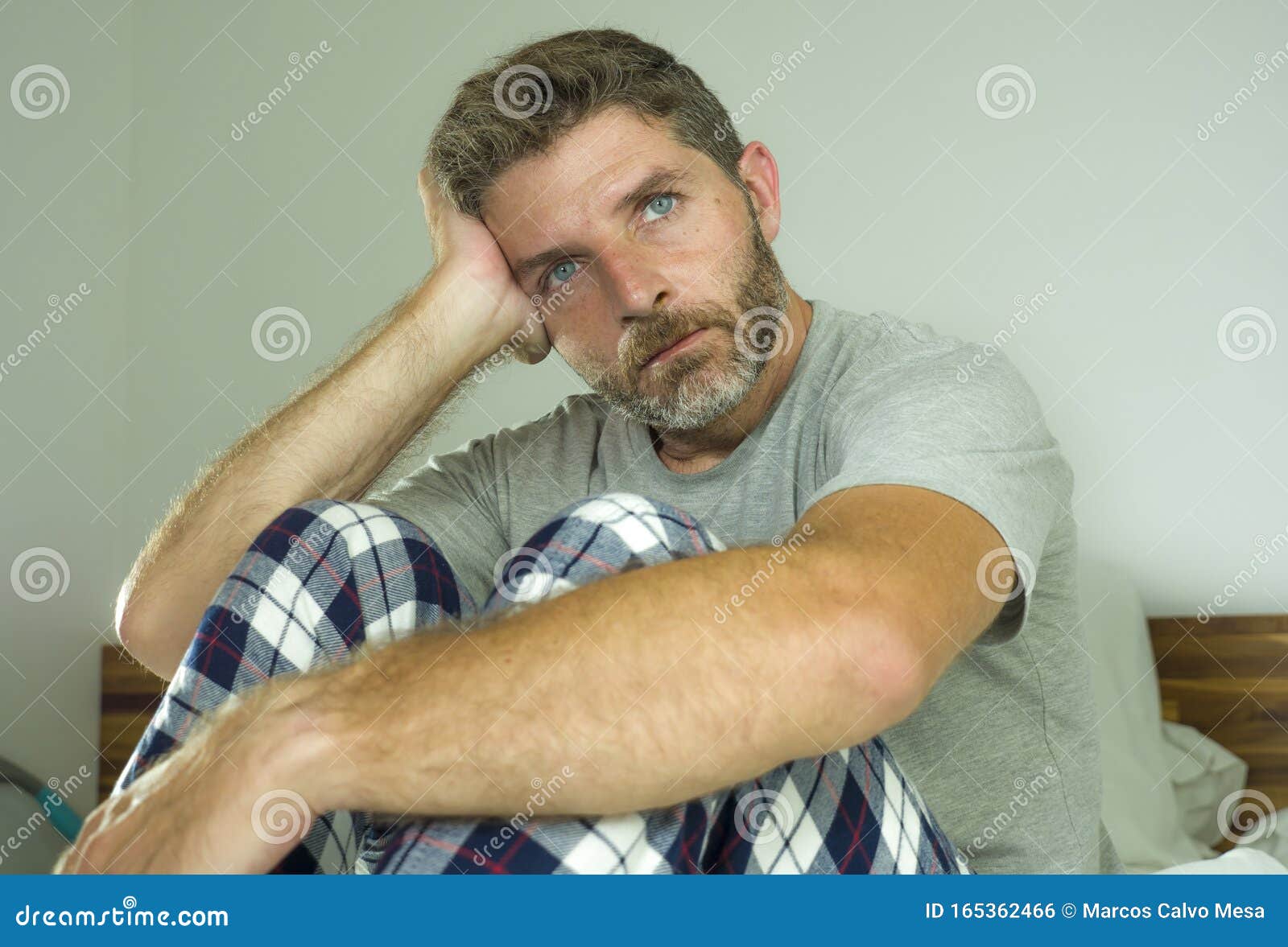 Young Sad and Depressed Man Lying Thoughtful and Pensive on Bed Looking ...