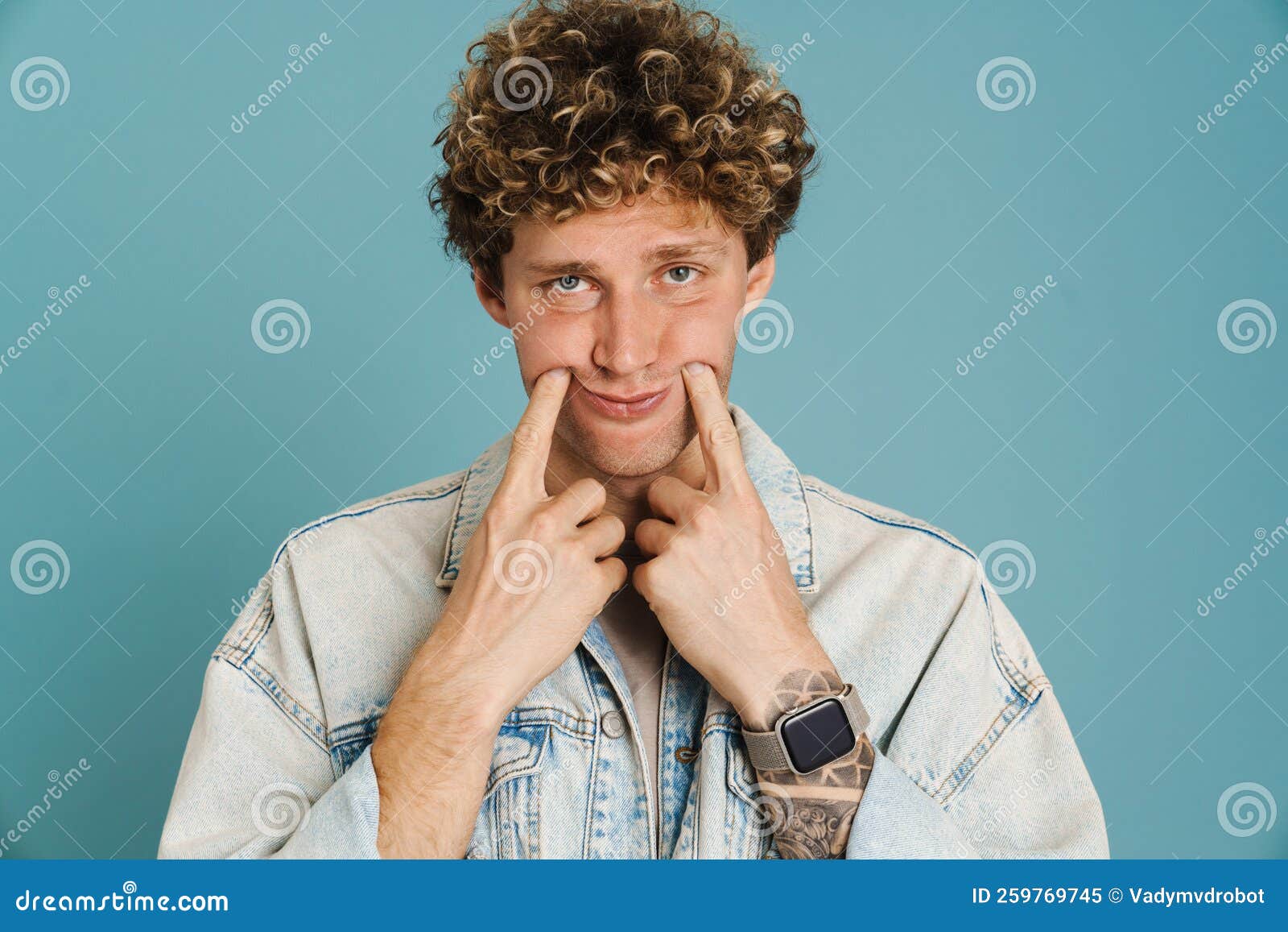 Young Sad Man Wearing Jacket Making His Smile and Looking at Camera ...