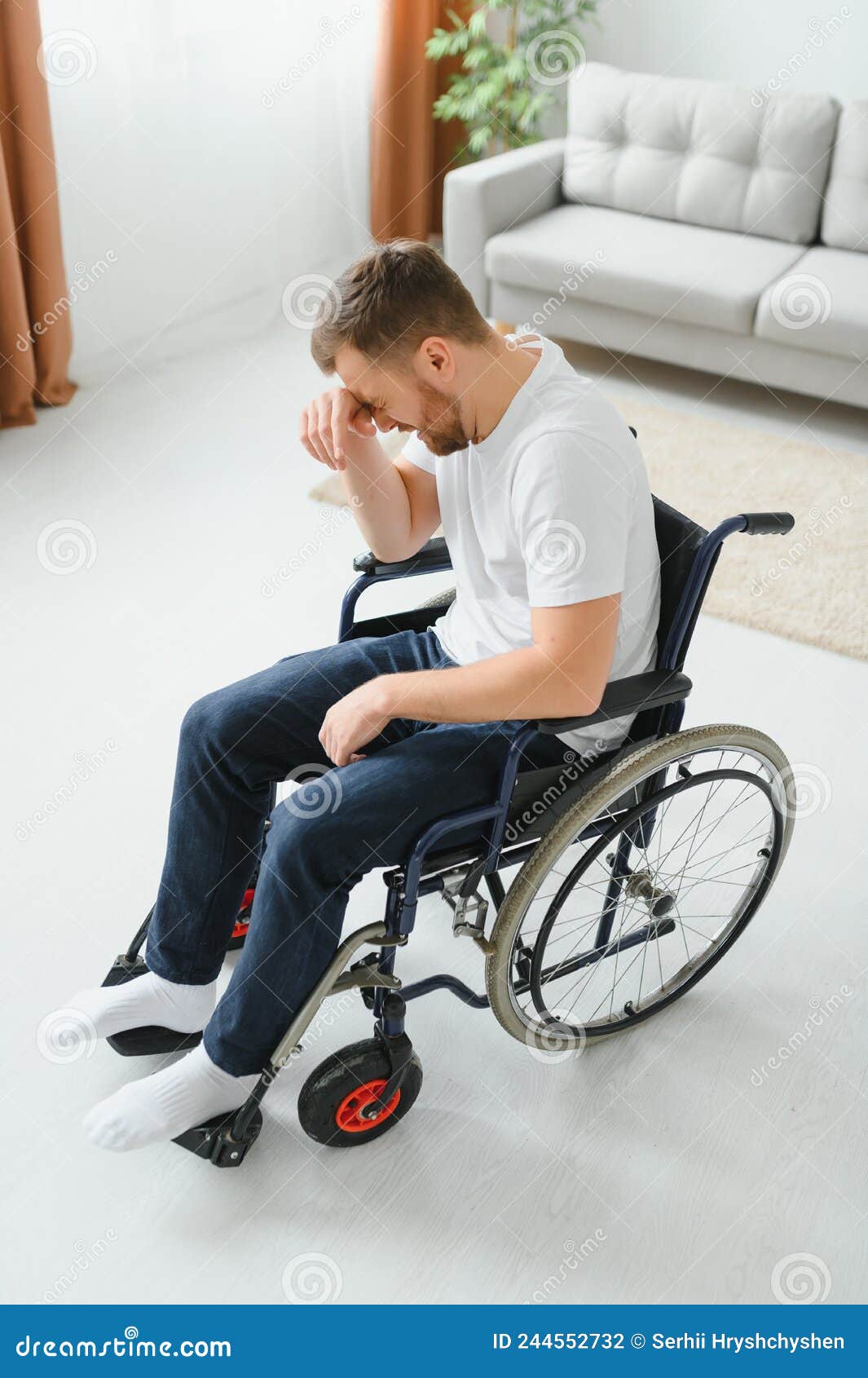 Young Sad Man in a Wheelchair at Home Stock Photo - Image of crying ...