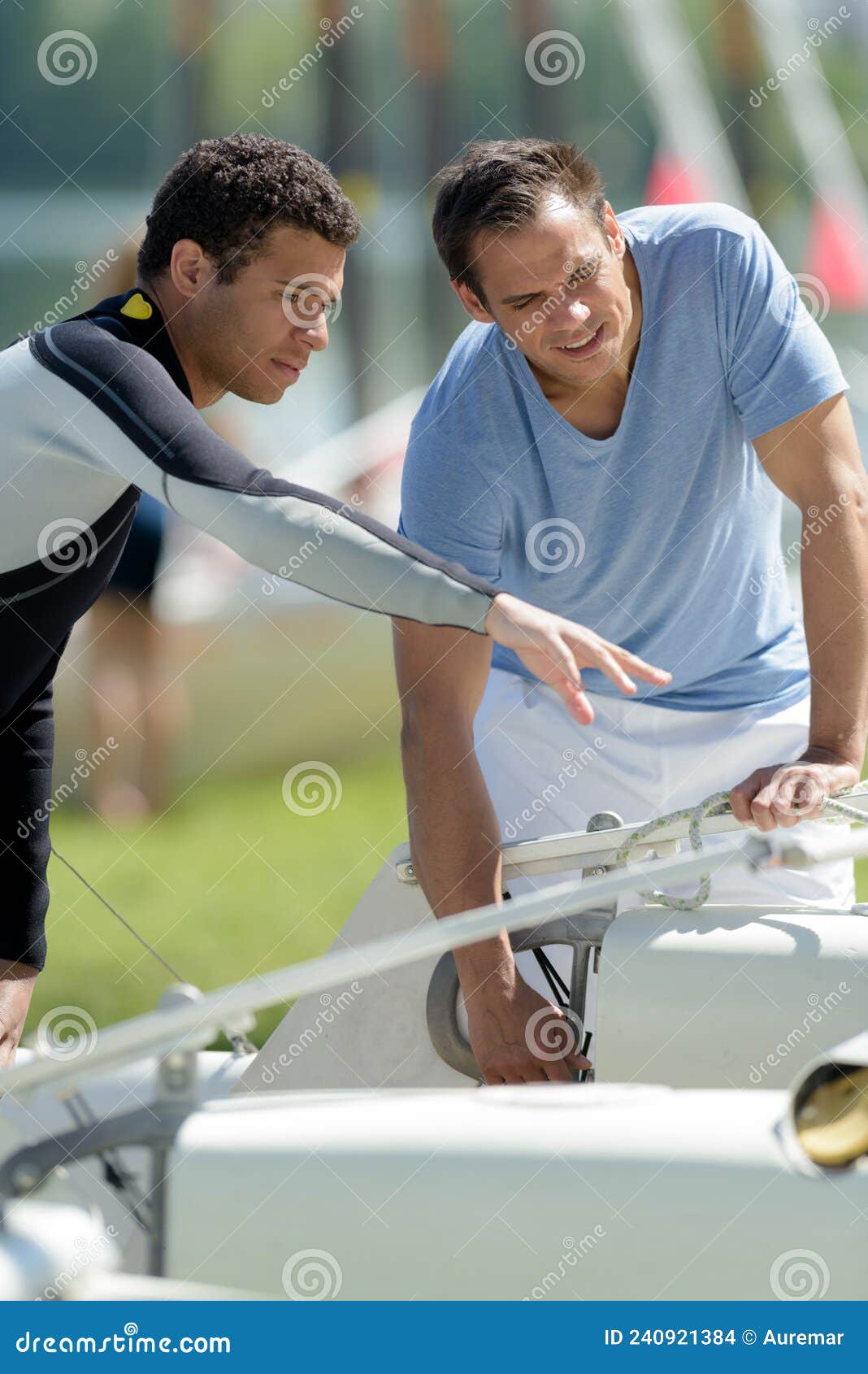 Young Sailing Instructor Instructs with Student Stock Photo - Image of ...