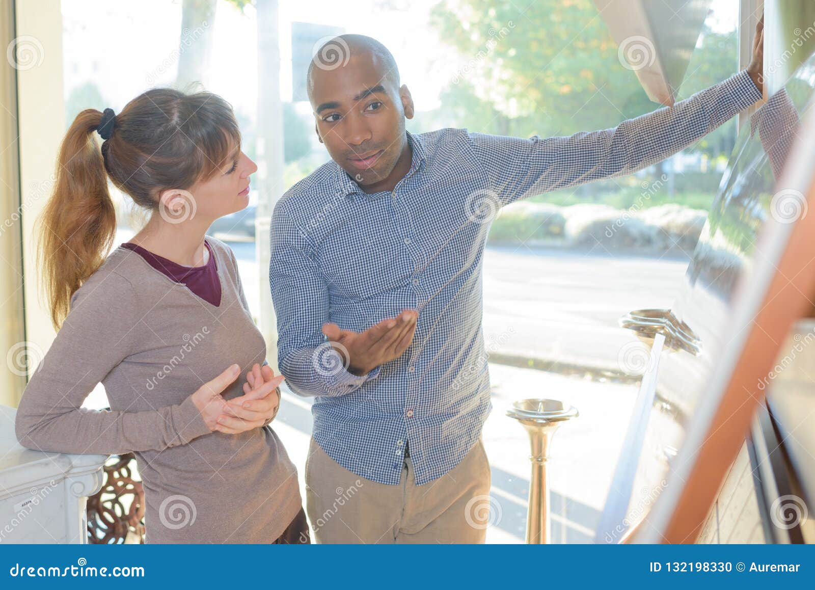 Young Salesman Advising Female Client in Furniture Store Stock Photo ... Young Salesman Advising Female Client in Furniture Store Stock Photo ...