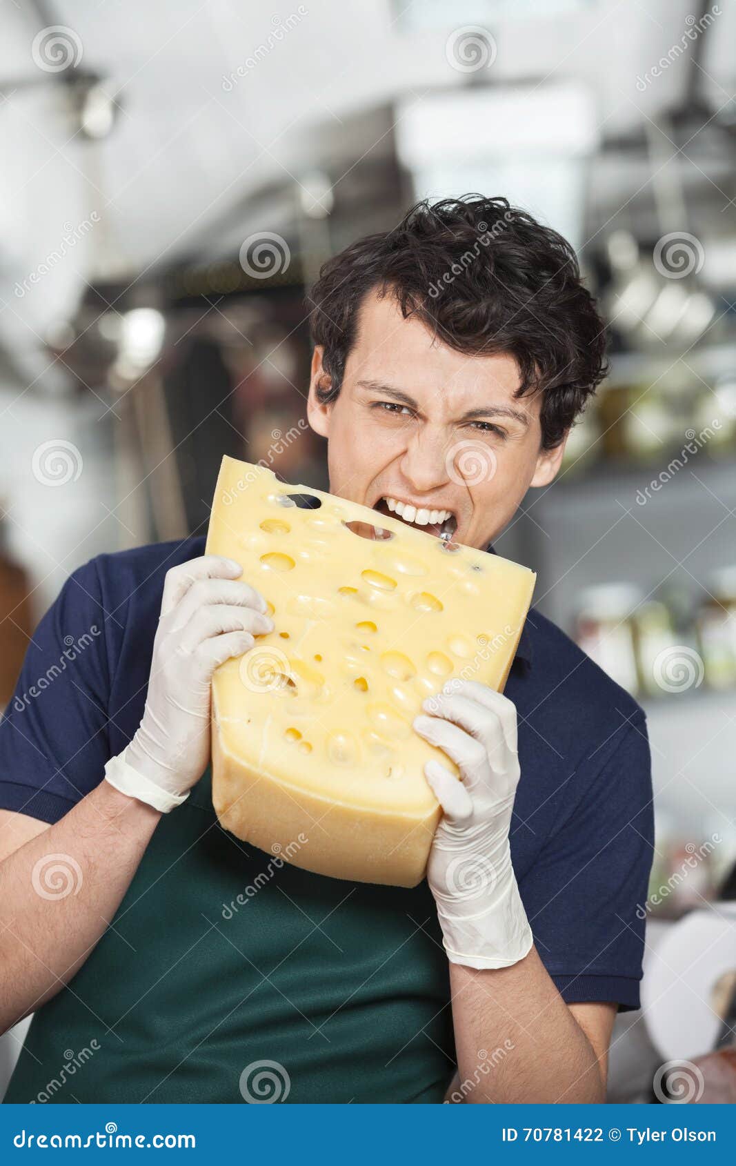 Young Salesman Biting Cheese in Store Stock Photo - Image of large ...