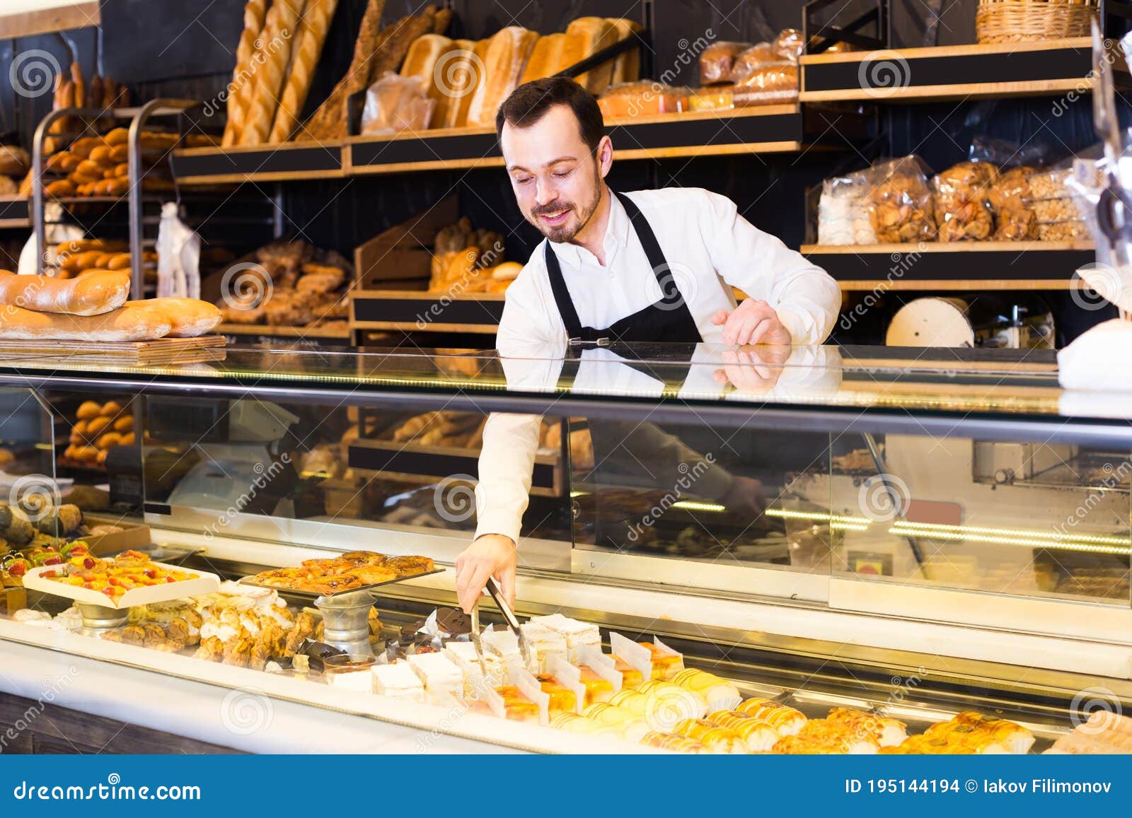 Salesman Shows the Types of Cakes Stock Photo - Image of helpful ...