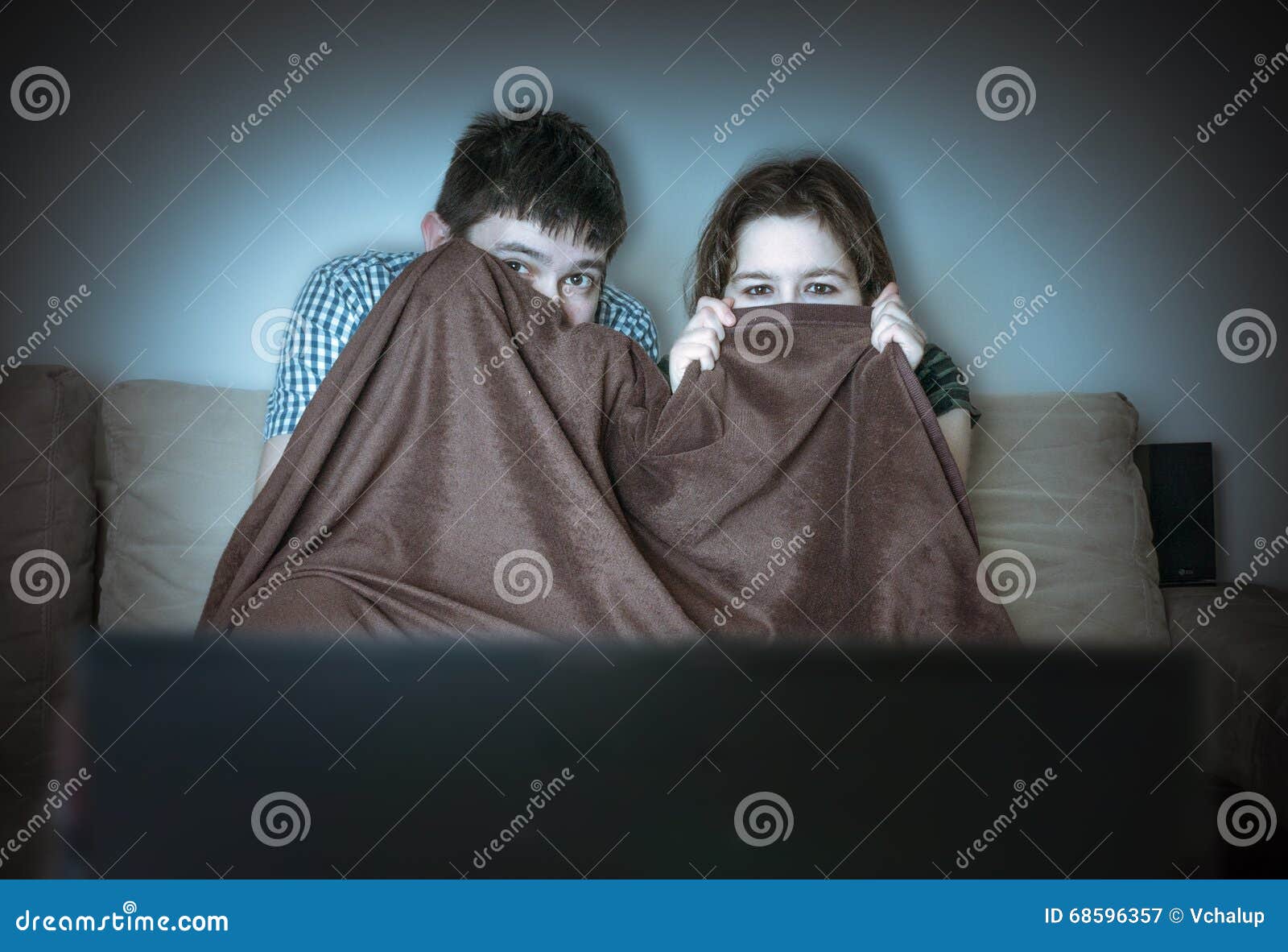 Young Scared Couple is Watching Horror on TV. Pair is Covering with ...
