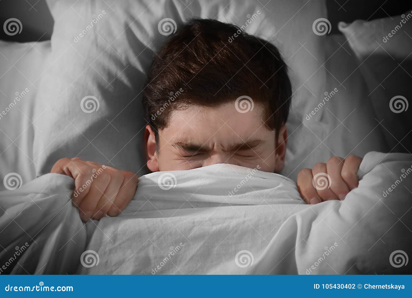 Young Scared Man Lying in Bed Stock Photo - Image of lying, emotional ...