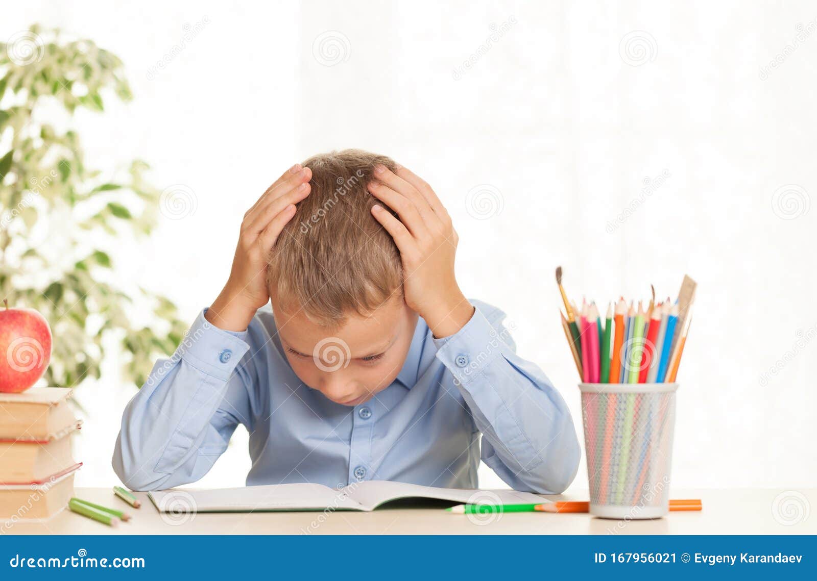 Young Schoolboy Sitting at the Table and Doing Homework Stock Image ...