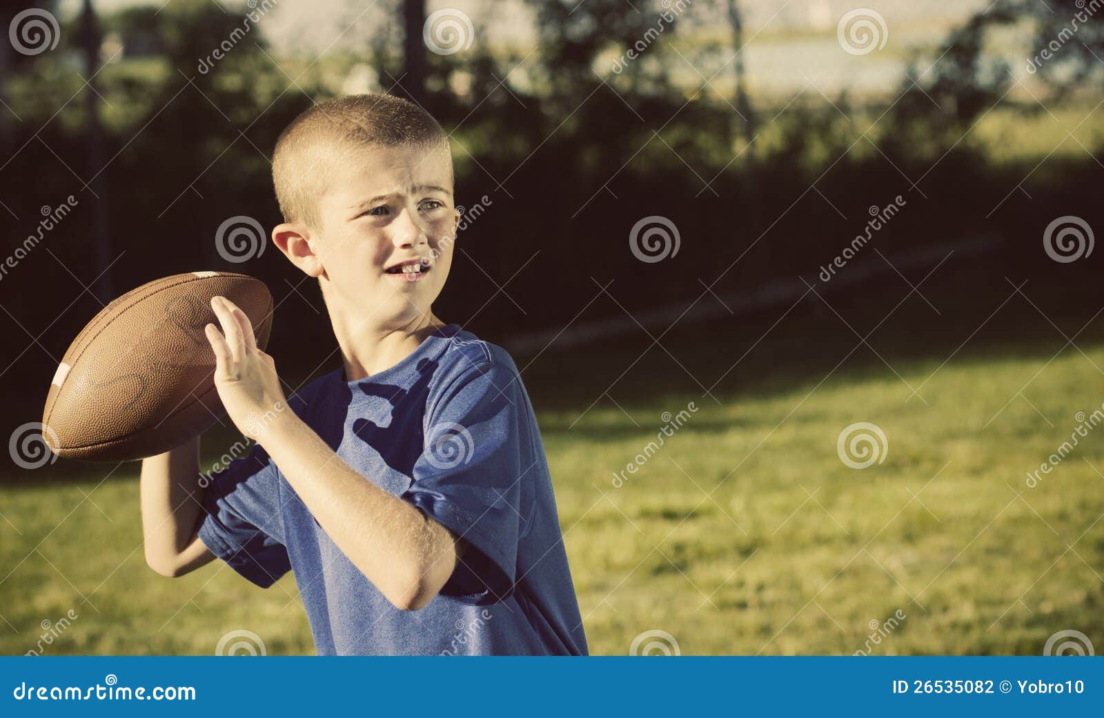 Young Schoolyard Quarterback Stock Photo - Image of copy, grass: 26535082