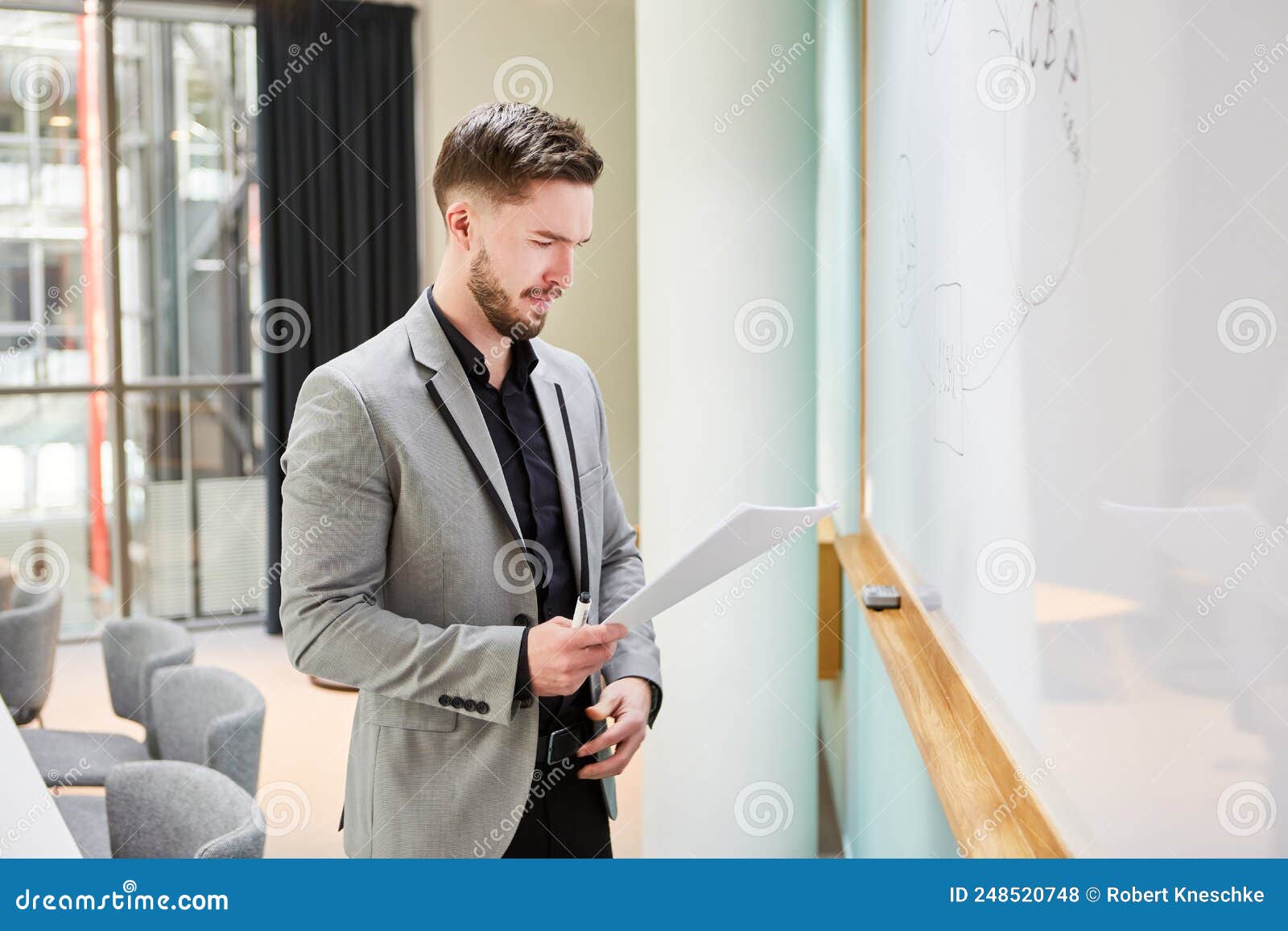 Speaker with Papers for a Presentation on the Whiteboard Stock Photo ...