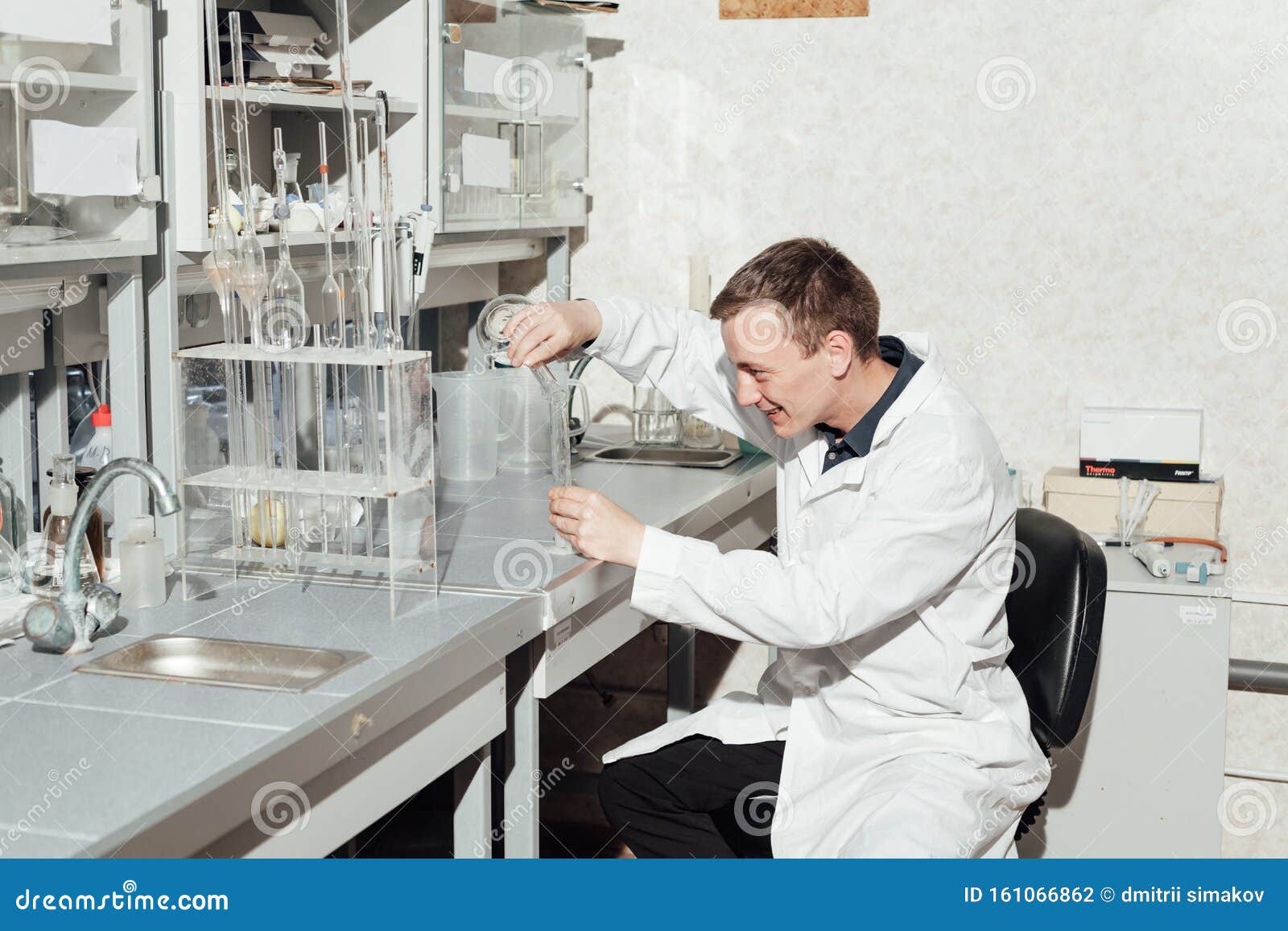 Young Scientist Conducts Chemical Experiments in the Laboratory Stock ...