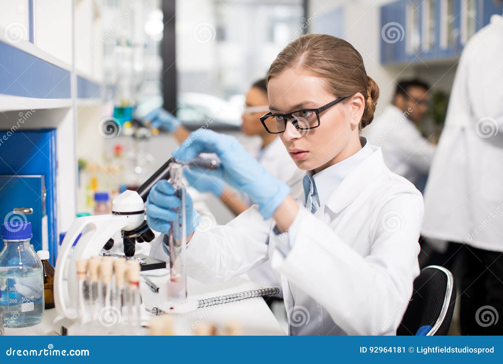 Young Scientist in Eyeglasses Making Experiment in Research Laboratory ...