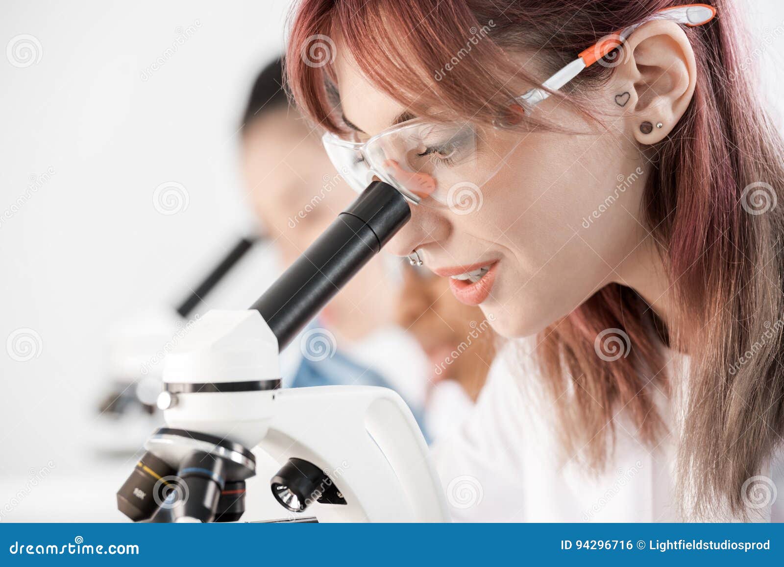 Young Scientist in Protective Goggles Working with Microscope in ...