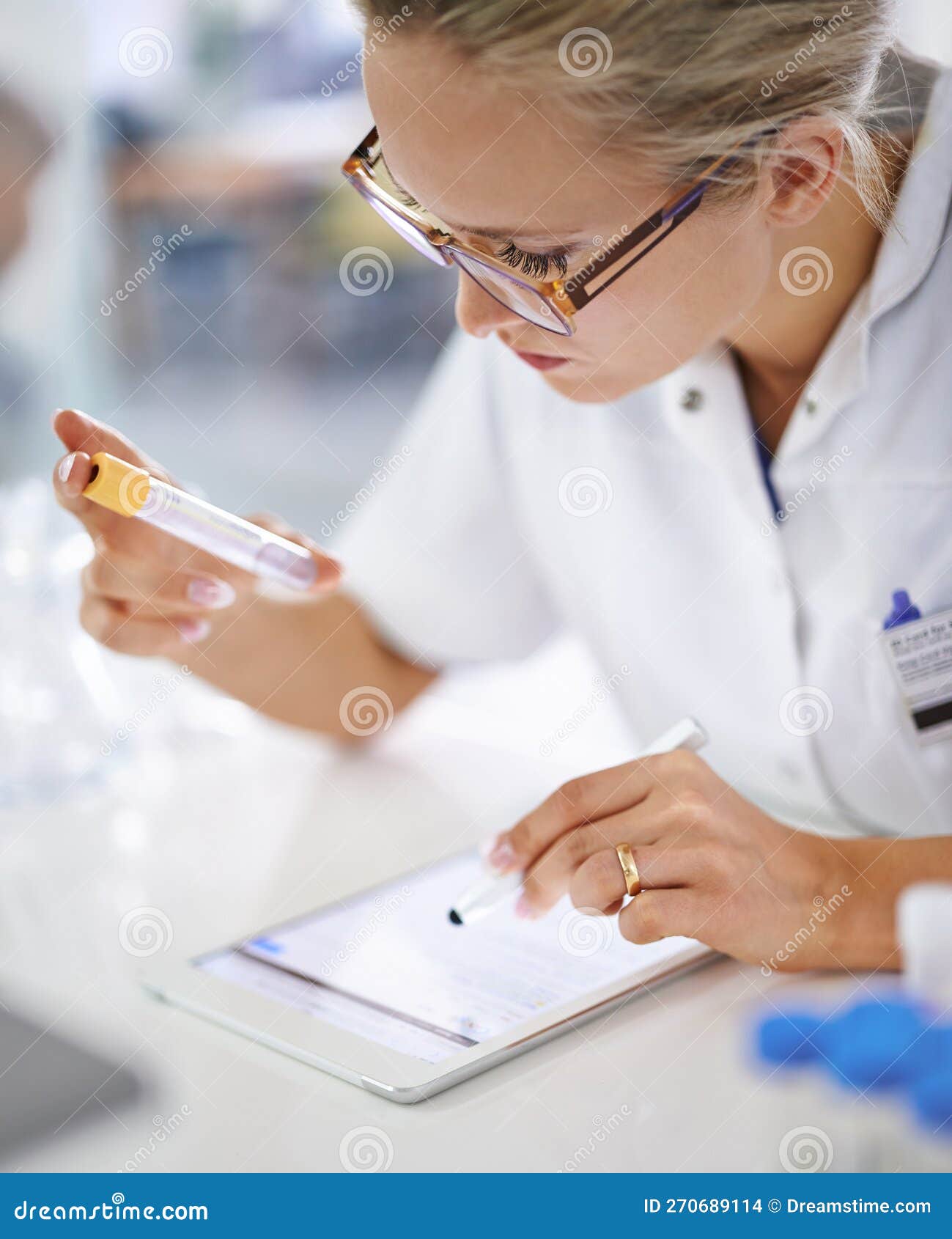 Research and Development. a Young Scientist Recording Her Findings on a ...