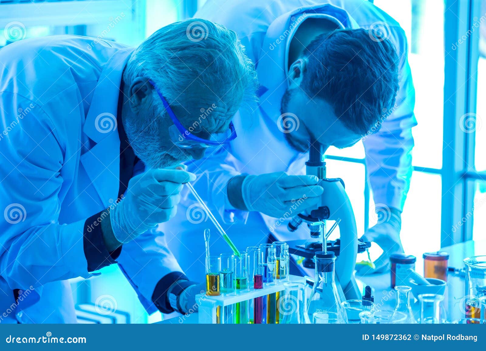 Young Scientist Research Using Microscope with Senior Man Supervisor ...