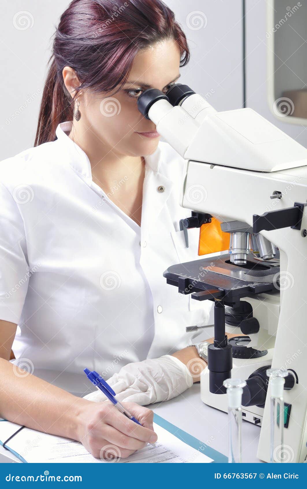 Young Scientist Studying New Substance or Virus with Microscope Stock ...