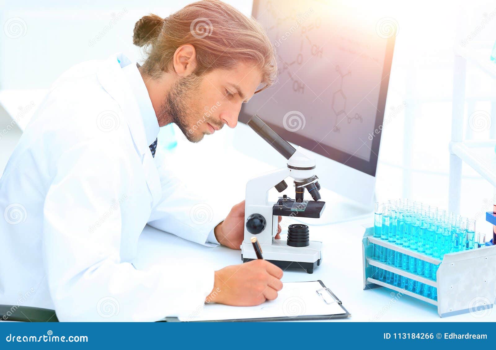 Laboratory Worker Sitting by Table with Microscope Stock Photo - Image ...