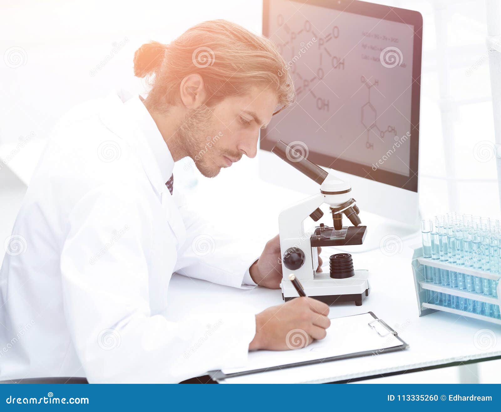 Laboratory Worker Sitting by Table with Microscope Stock Photo - Image ...