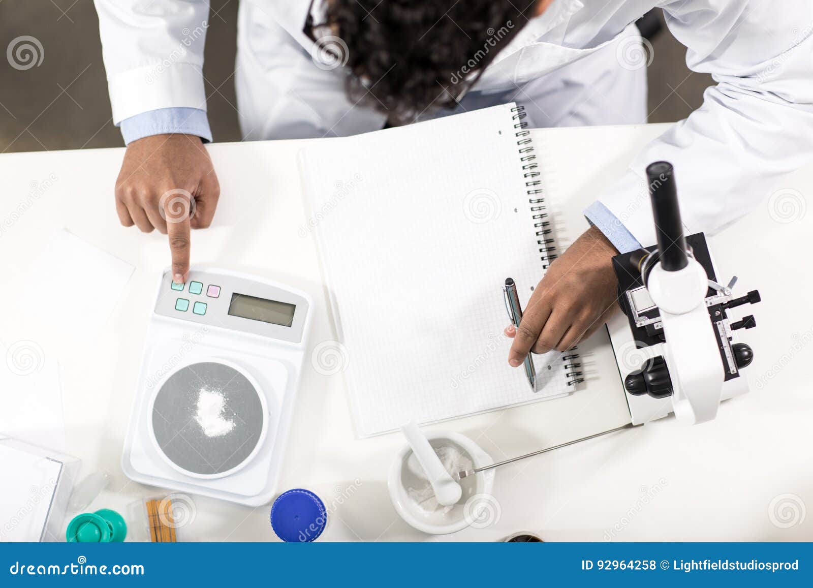 Young Scientist Working with Electronic Scales and Taking Notes in ...