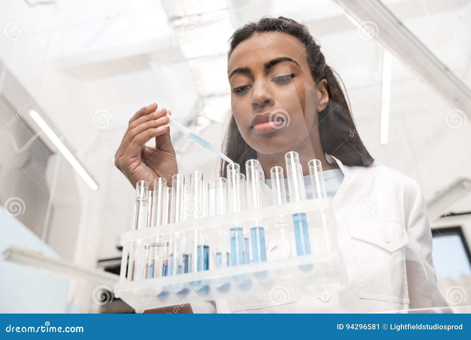 Young Scientist Working with Test Tubes and Reagents in Chemical Lab ...