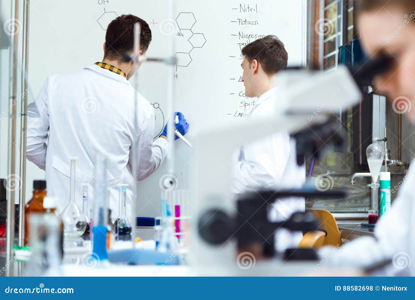 Young Scientists Carrying Out an Experiment in a Laboratory. Stock ...
