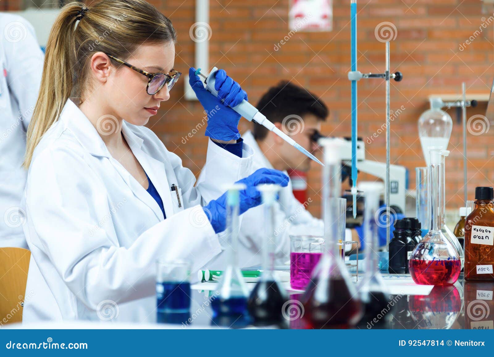 Young Scientists Carrying Out an Experiment in a Laboratory. Stock ...