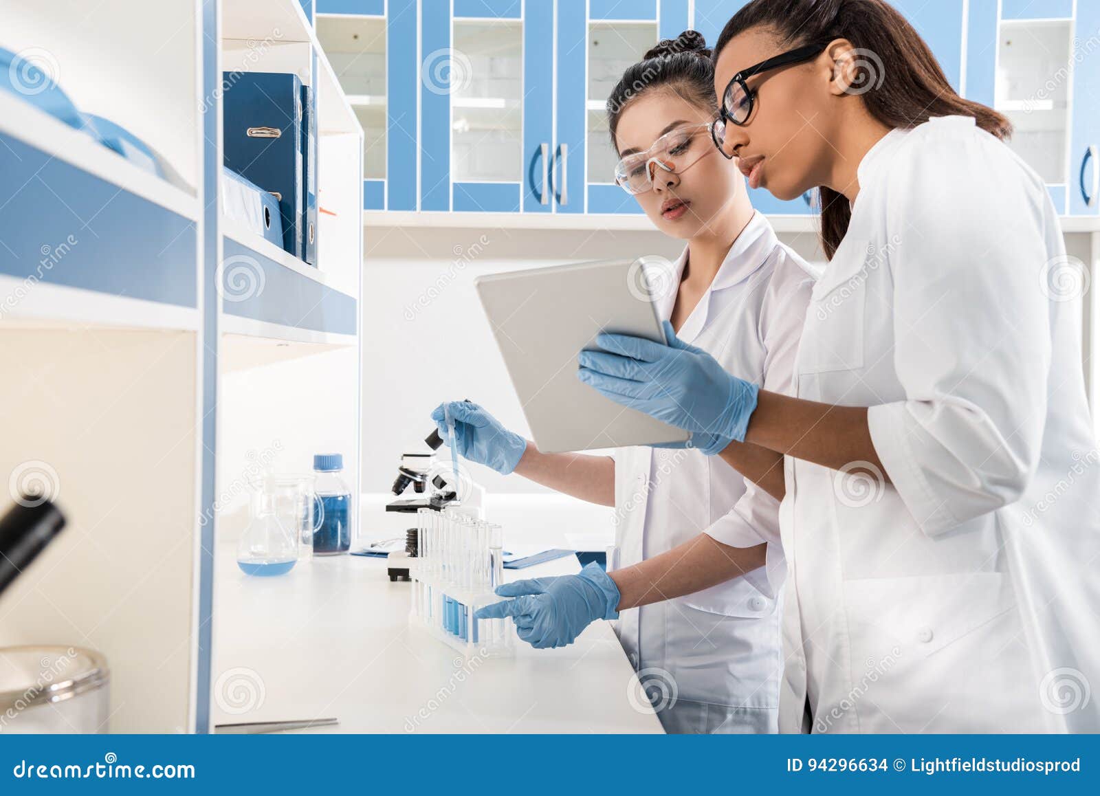 Young Scientists Using Digital Tablet while Making Experiment in ...