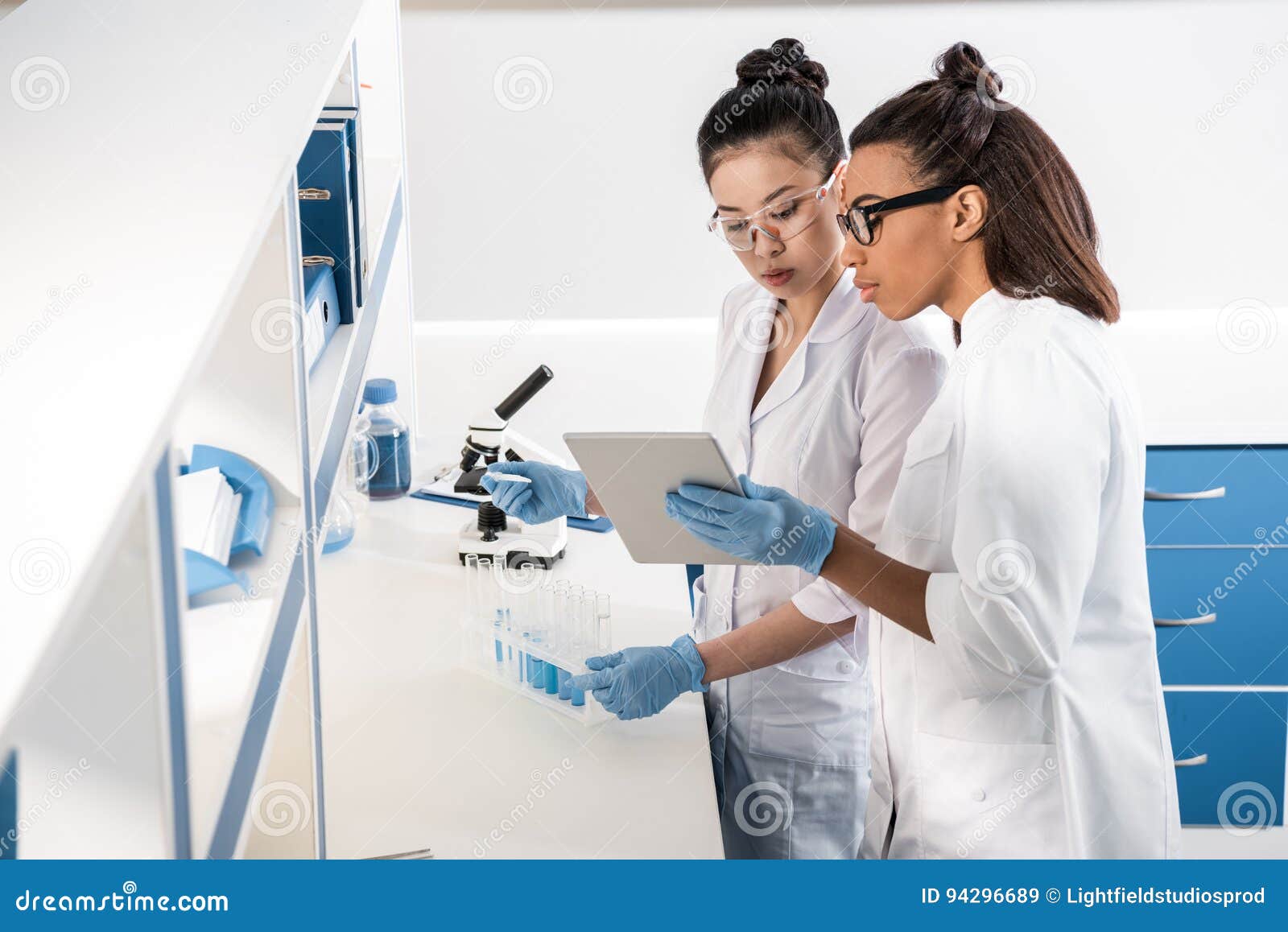 Young Scientists Using Digital Tablet while Making Experiment in ...