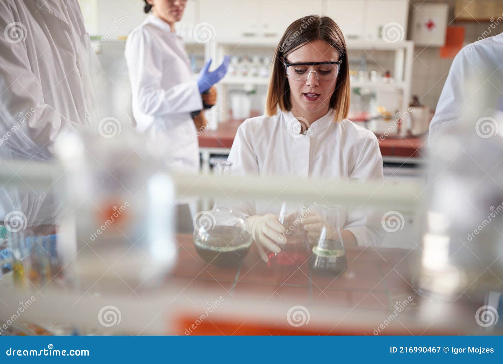 Young Scientists Observing The Chemical In The Test Tube At The ...