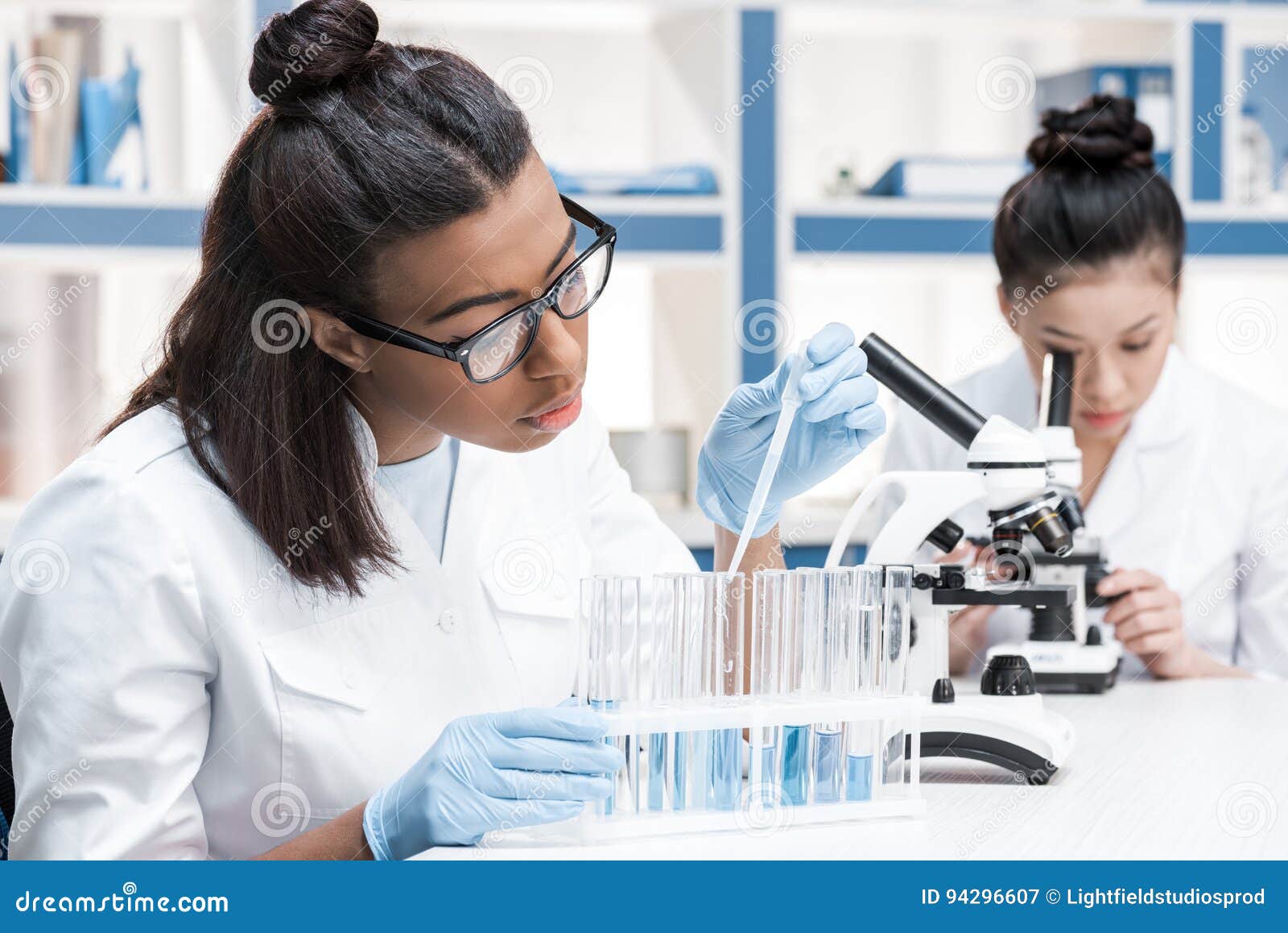 Young Scientists Working with Microscope and Test Tubes in Chemical ... Young Scientists Working with Microscope and Test Tubes in Chemical ...