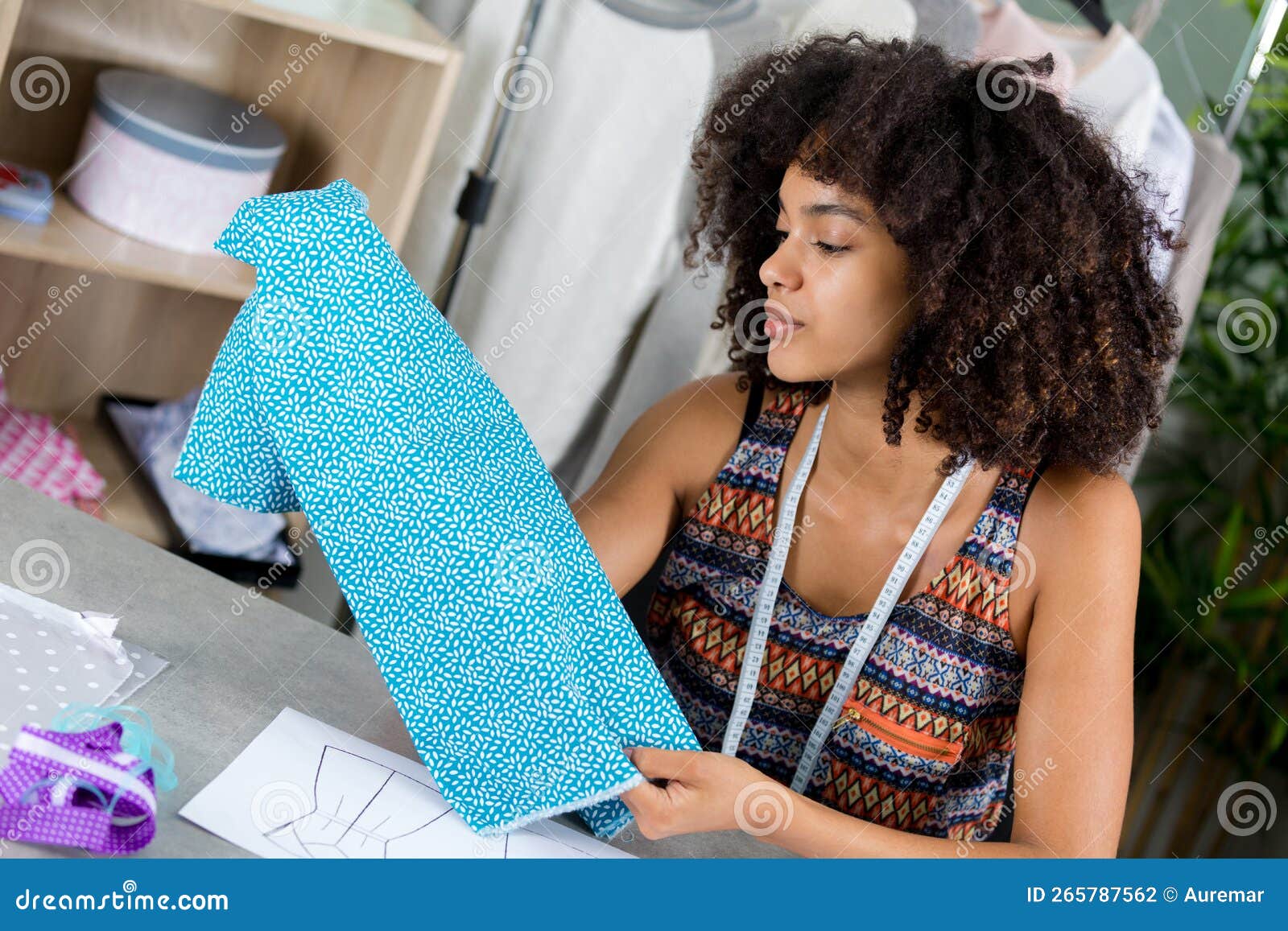 Young Seamstress in Studio Looking at Material Stock Photo - Image of ...