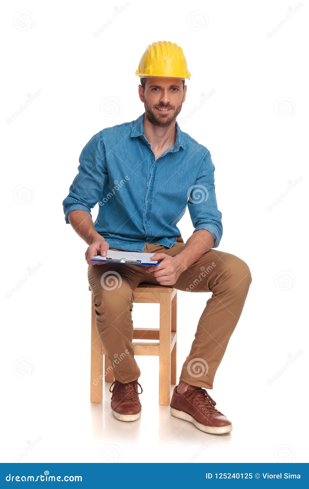 Young Seated Construction Engineer with Clipboard Stock Image - Image ...