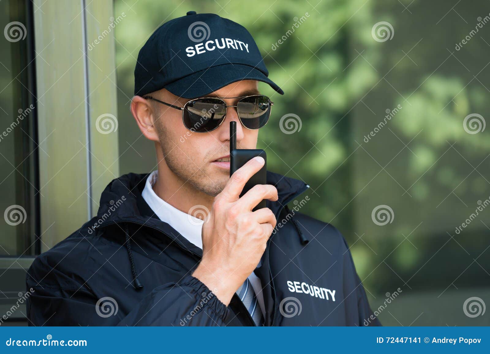 Young Security Guard Talking on Walkie-talkie Stock Image - Image of ...