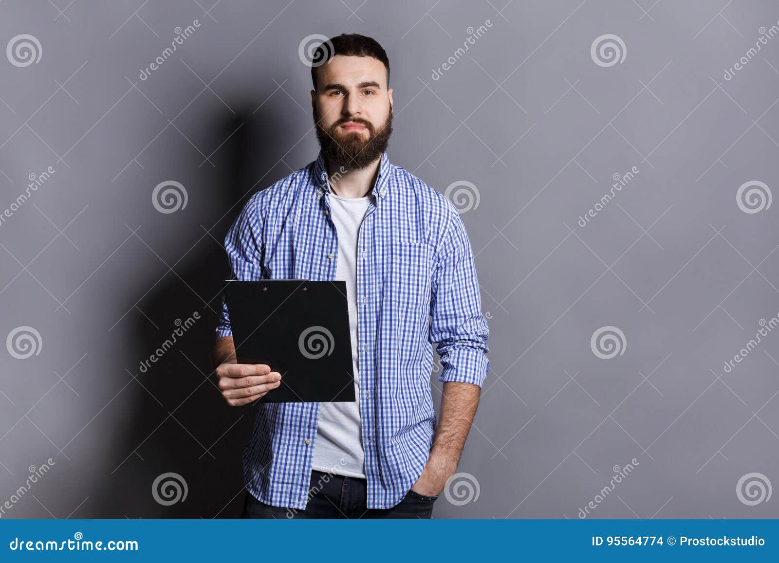 Young Serious Bearded Man Standing with Folder Stock Photo - Image of ...