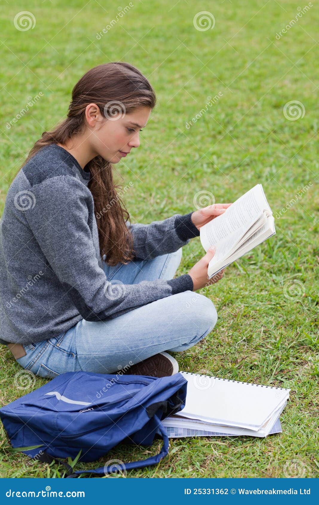 Young Serious Girl Reading a Book while Sitting Stock Photo - Image of ...