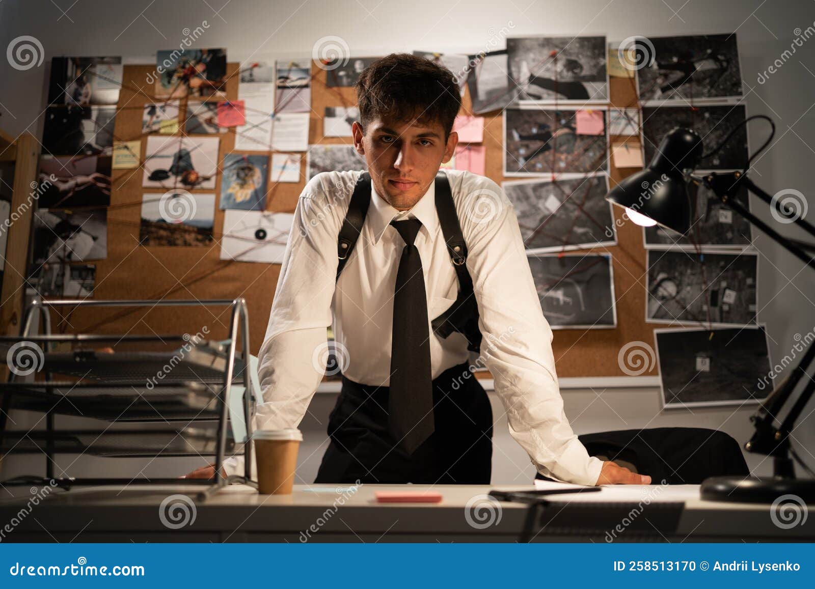 Young Serious Male Detective in Uniform Bending Over Workplace with ...