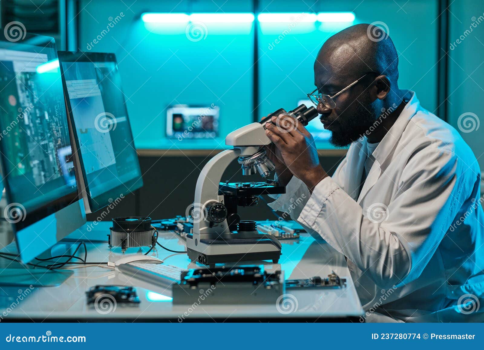 Young Serious Male Researcher in Whitecoat Looking in Microscope Stock ...